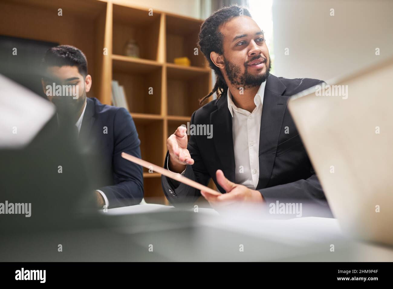 African businessman discussing project planning in meeting or workshop ...