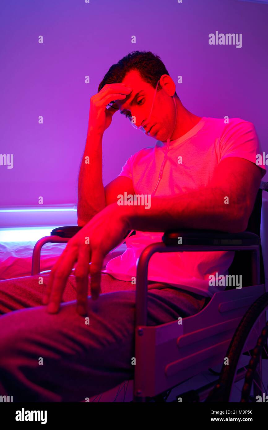 Man sitting in the room with pink light Stock Photo - Alamy