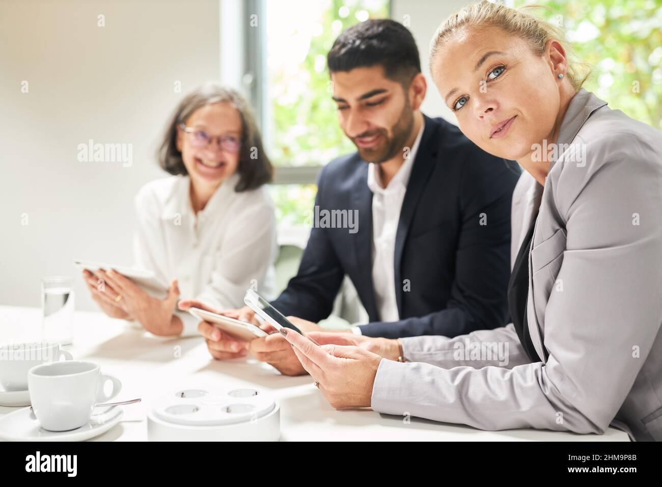 Three people in business team with tablet computer planning project in ...