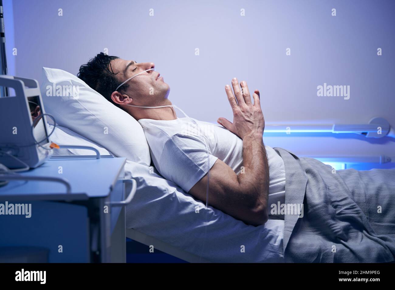 Man in white t-shirt resting after procedures Stock Photo - Alamy
