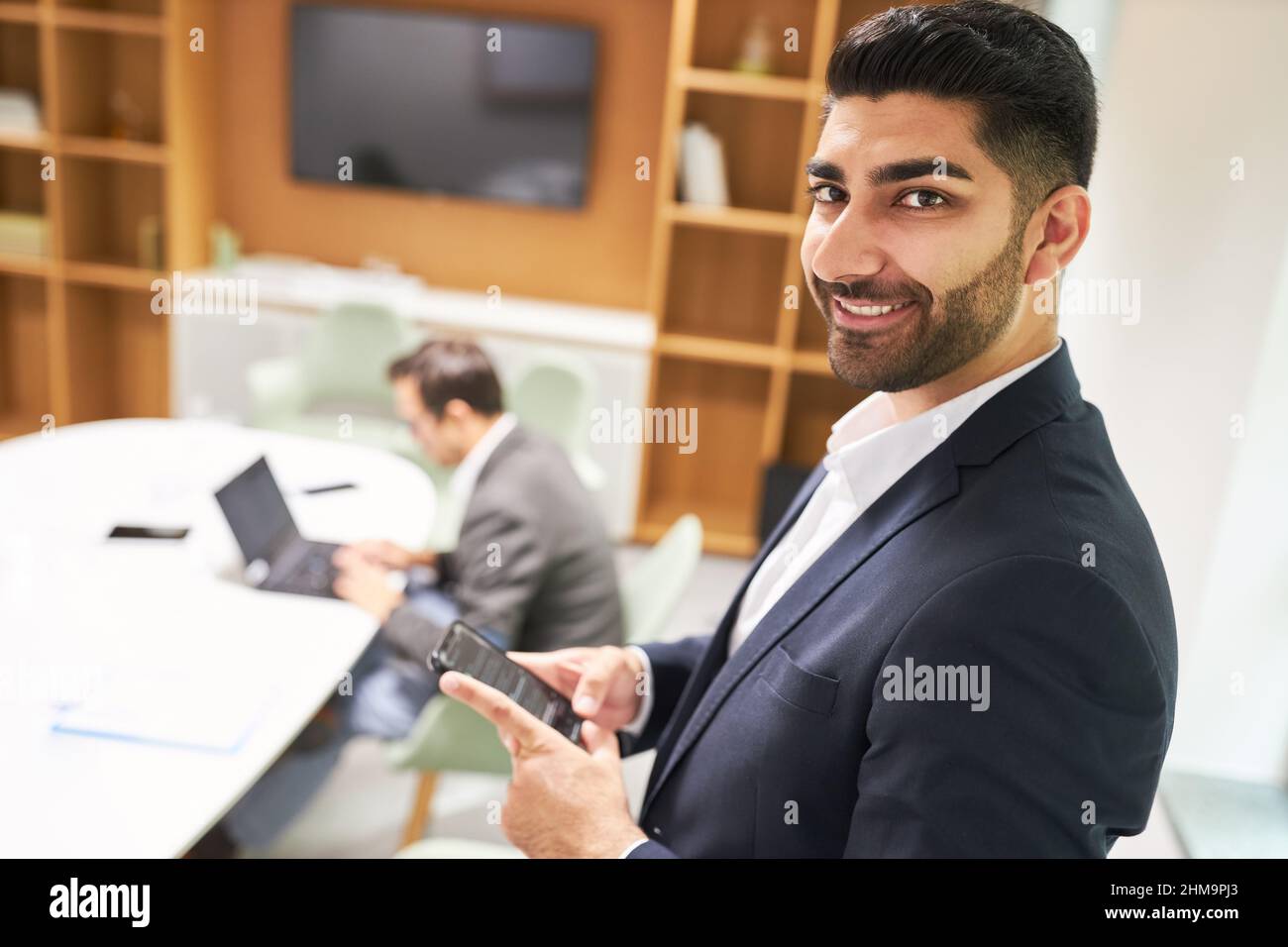 Business man as a successful start-up founder using smartphone in the ...