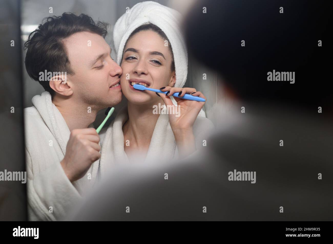 a young married couple brushing their teeth together. Dental hygiene ...