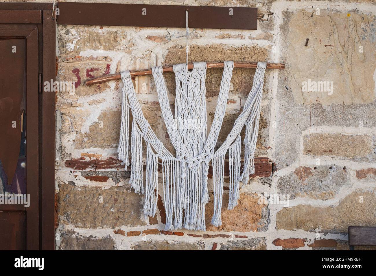 Wall mural in boho style made of cotton threads in natural color on a ...