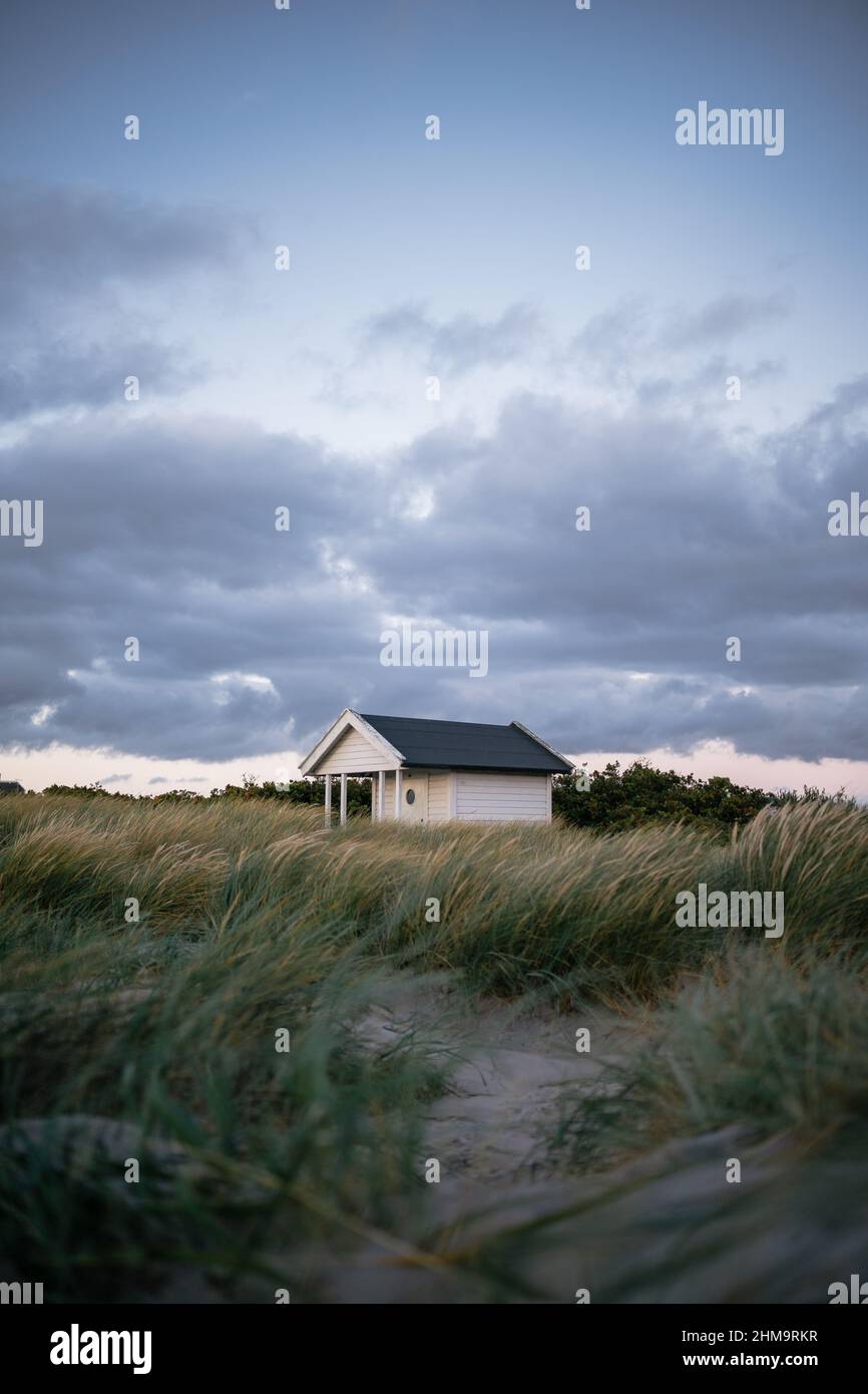 View of a wooden changing house near a beach on a cloudy day Stock ...