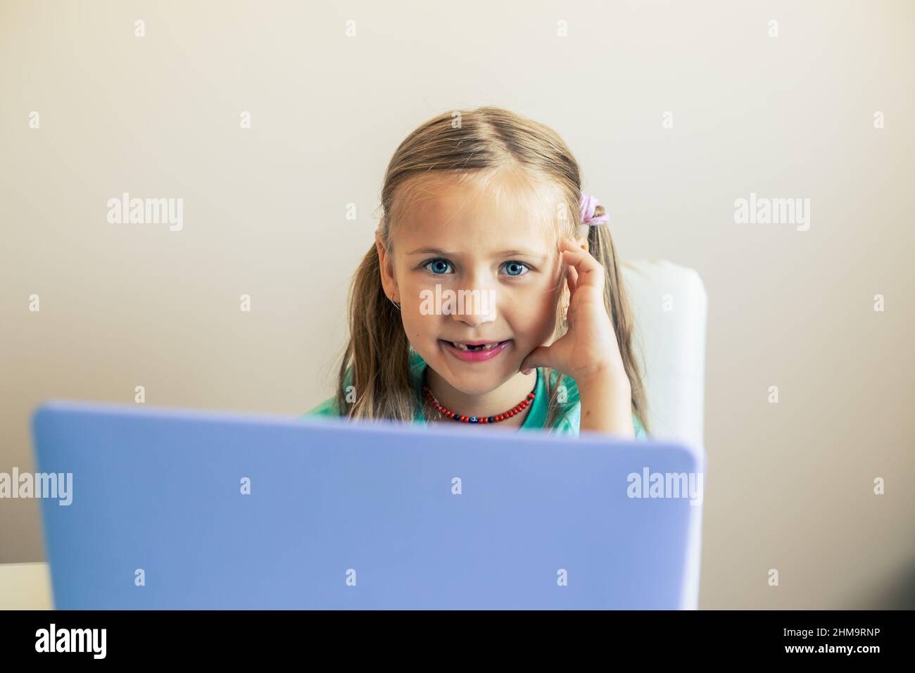 Little cute girl uses laptop to have video call Stock Photo - Alamy