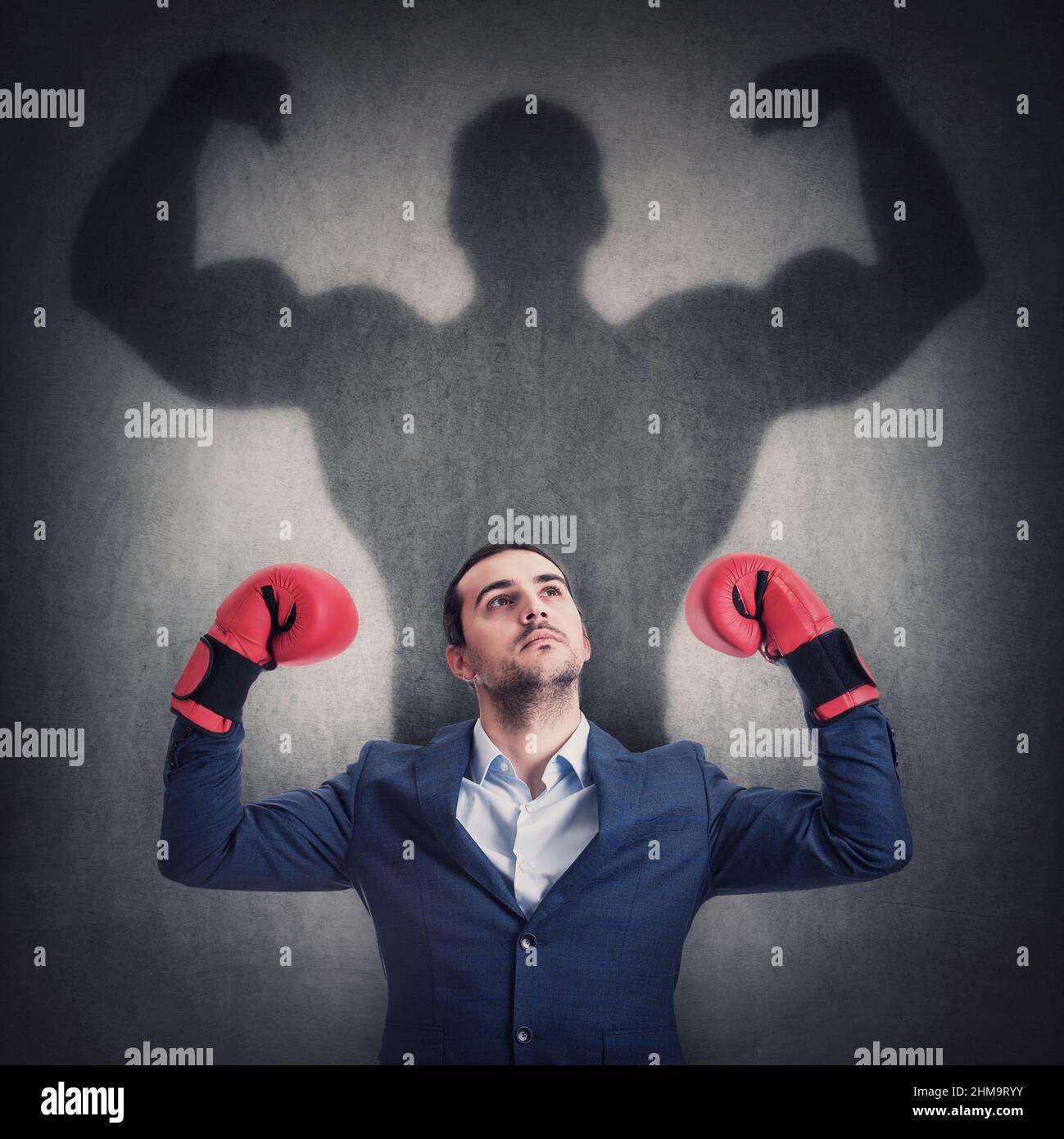 Confident businessman in suit with red boxing gloves celebrating ...