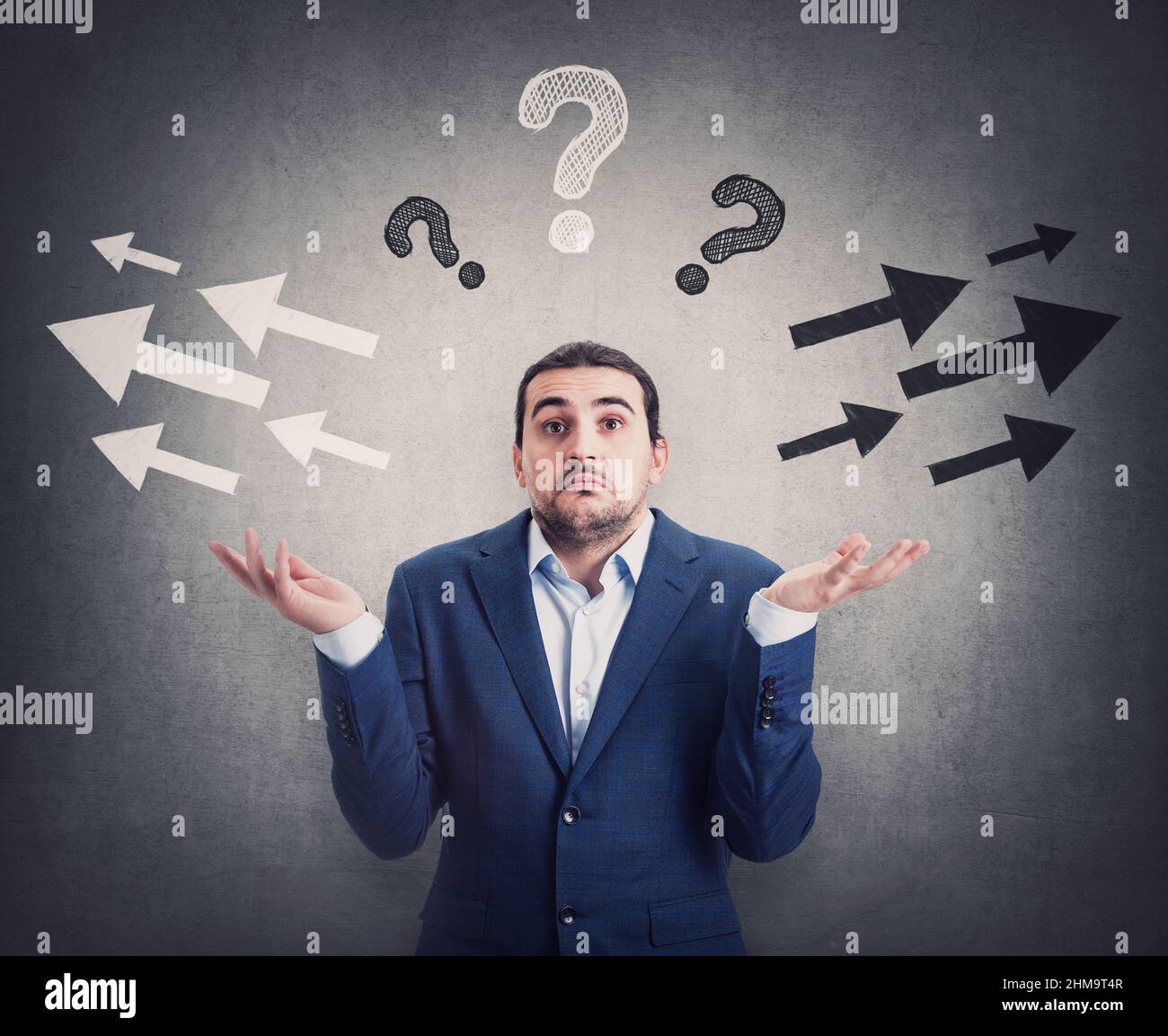 Perplexed businessman shrugs shoulders, hands outstretched, has doubts ...