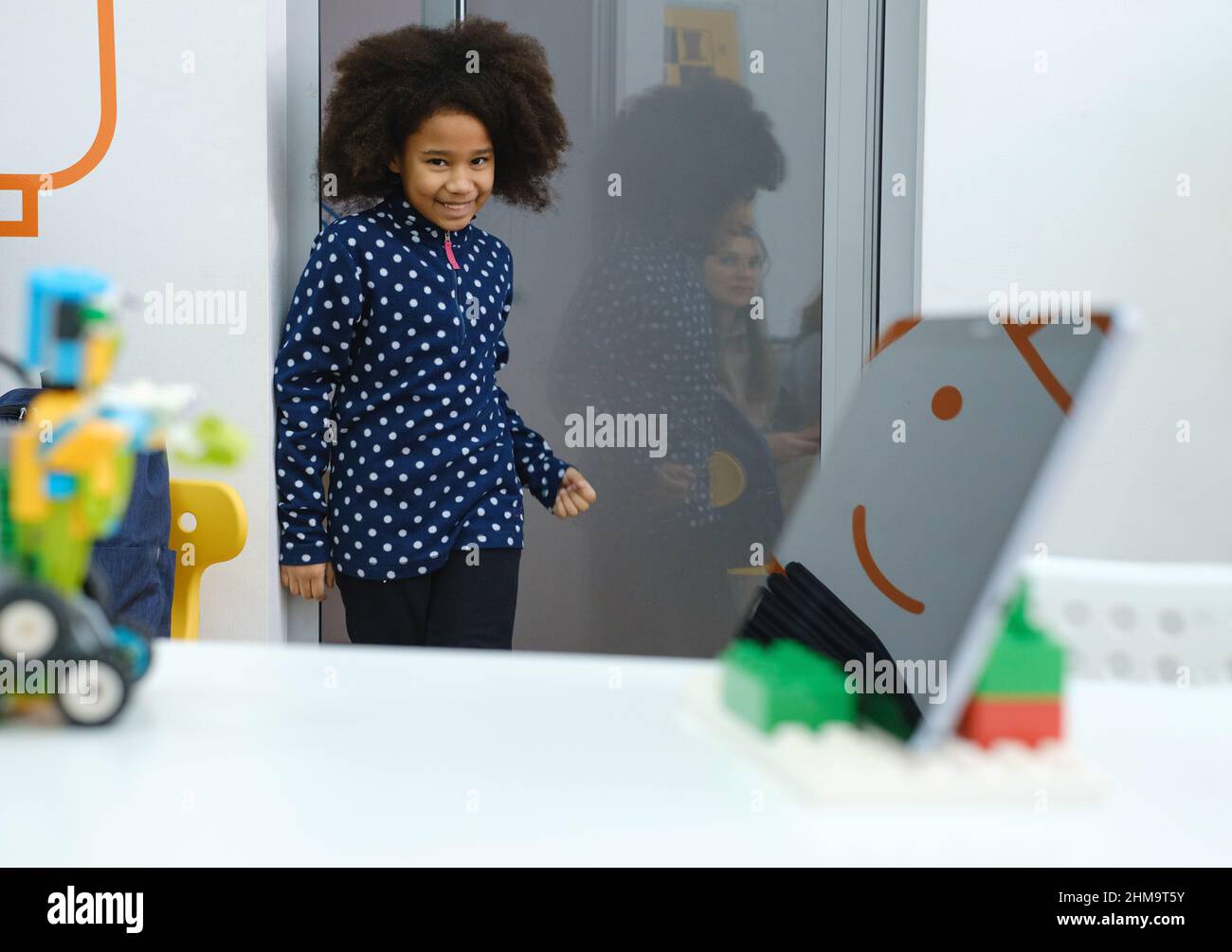 African American School girl entering modern class room door for ...
