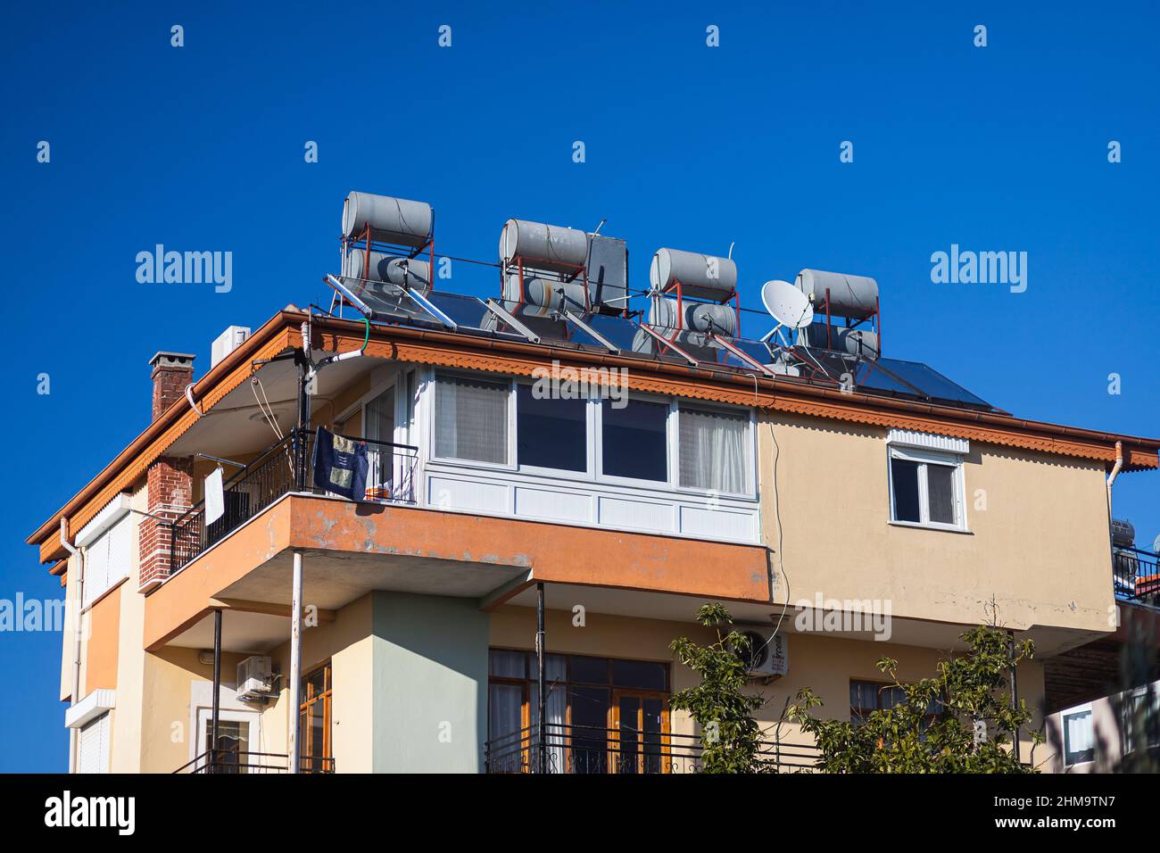 Colorful Turkish house with barrels of hot water on the roof and solar ...