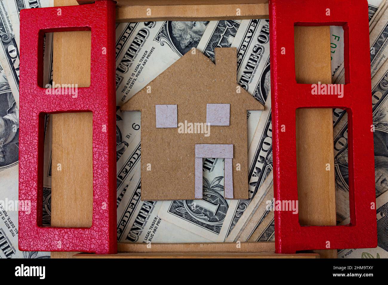 Brown paper house model with window frame on dollar banknotes. Concept ...