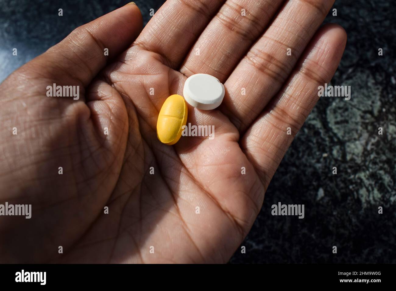 Person patient consuming prescribed medicines tablet pills in hand ...