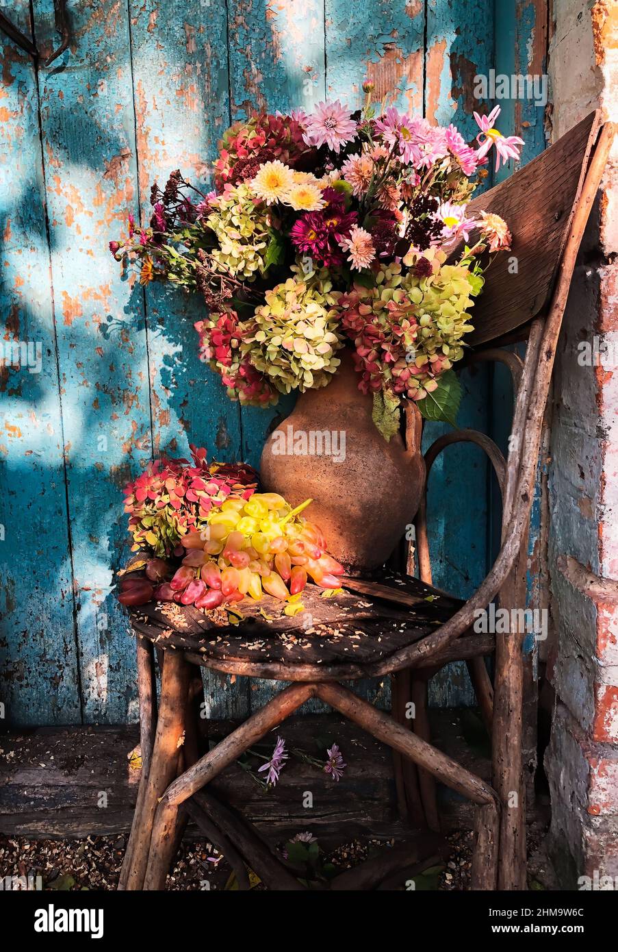 Romantic bouquet with hydrangea, aster, chrysanthemum and grapes in a ...
