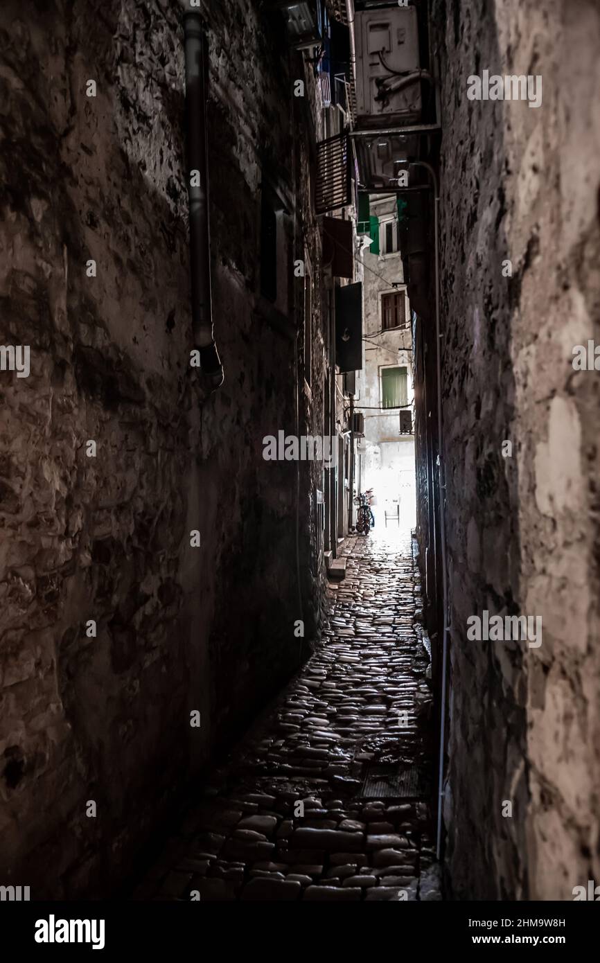 Creepy Narrow Alley With Light At Its End, Old Houses And Cobblestone ...
