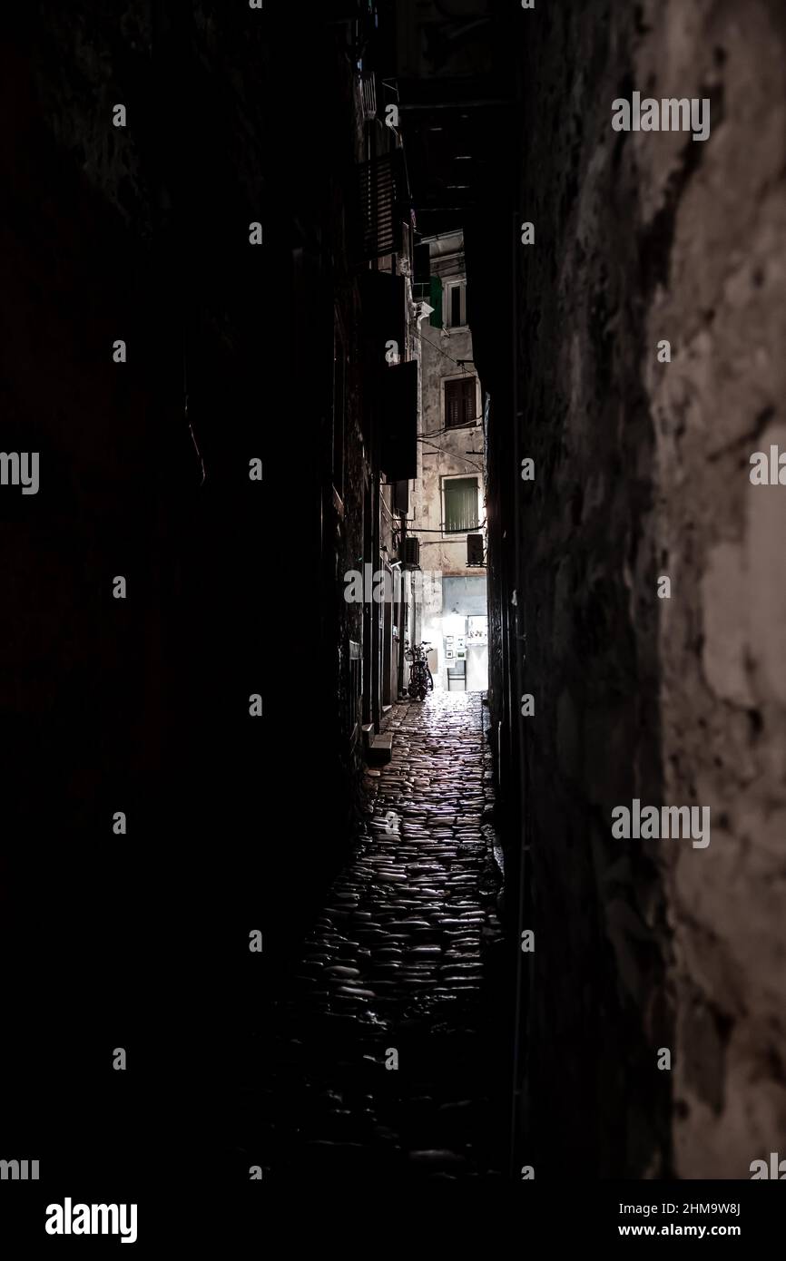 Creepy Narrow Alley With Light At Its End, Old Houses And Cobblestone ...