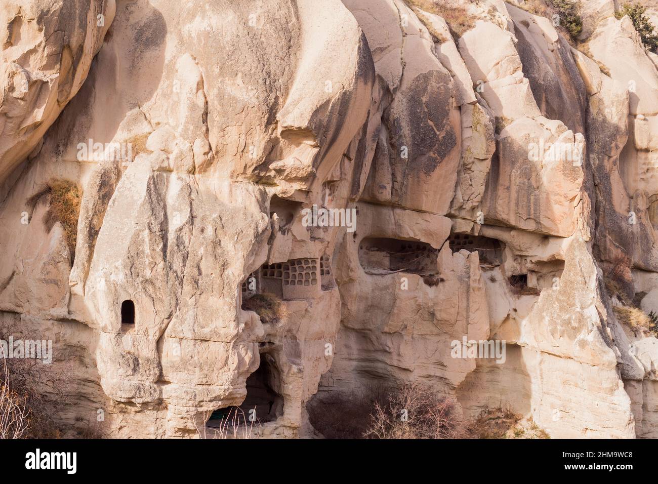 Cave houses and buildings in Cappadocia, Turkey. Stone peaks with doors ...