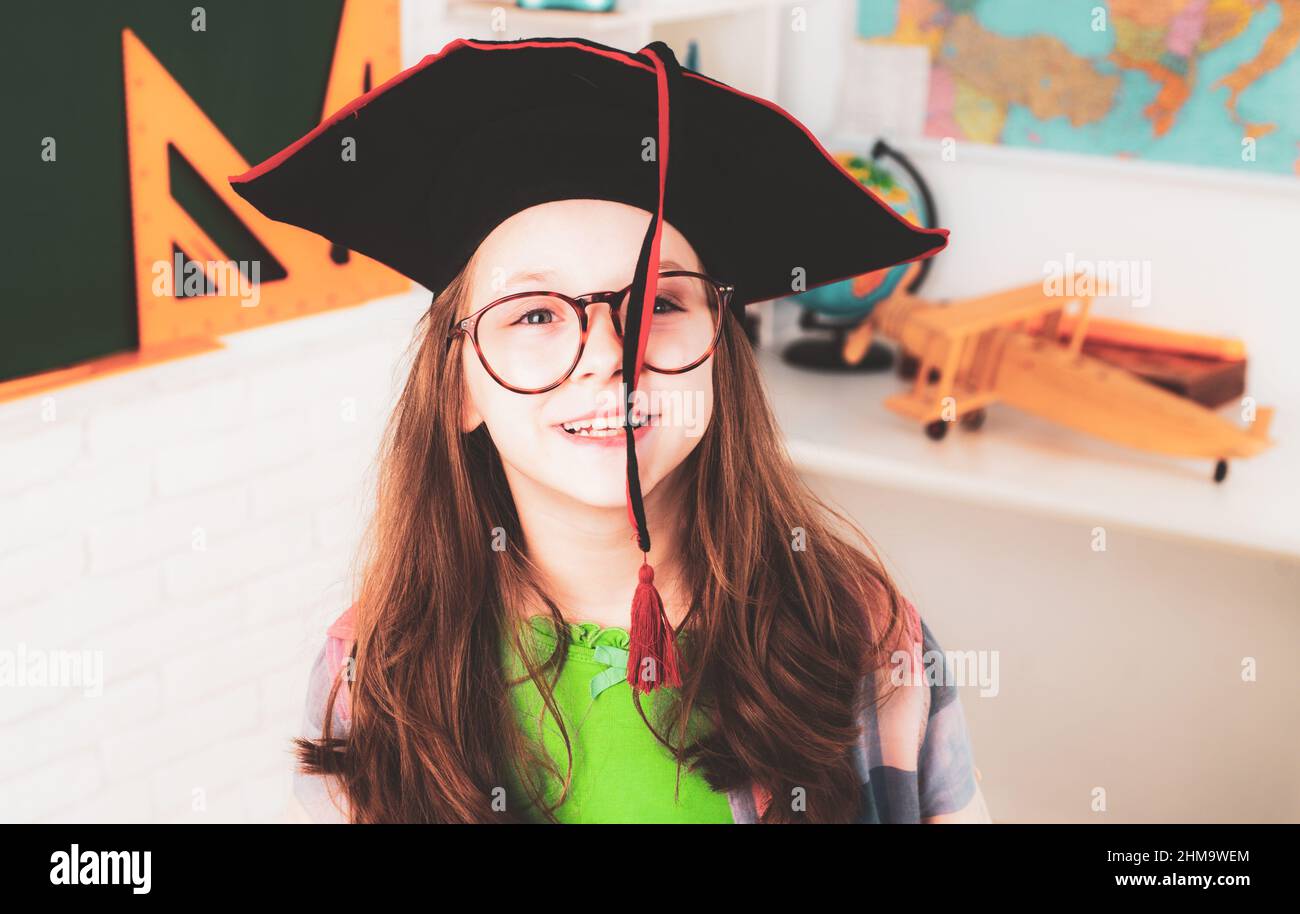 Funny little student girl in graduation cap. Child from elementary ...