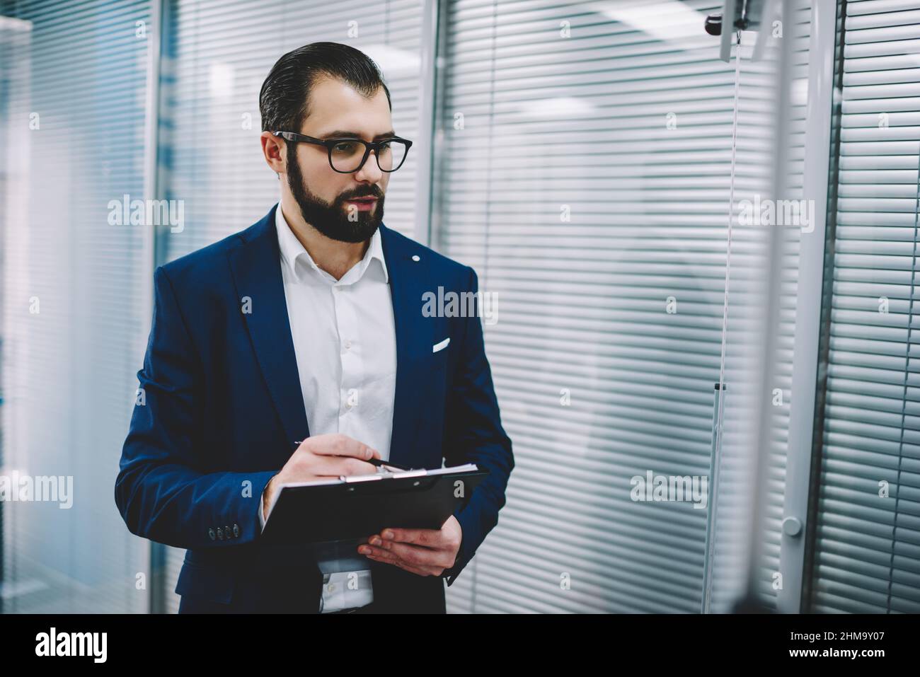 Serious adult businessman checking notes written on white board Stock ...