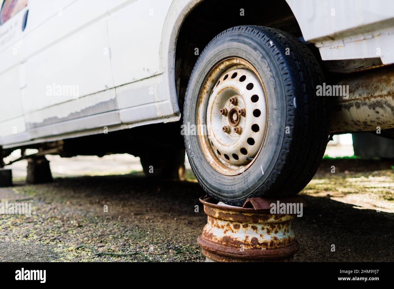Old rusty car wheel. Cracked tires and a rusted hubcaps Stock Photo - Alamy
