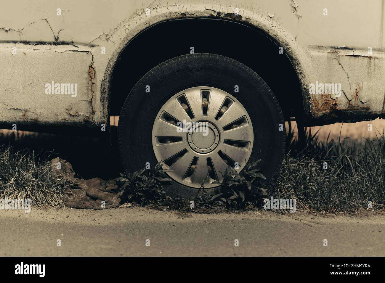 Old rusty car wheel. Cracked tires and a rusted hubcaps Stock Photo - Alamy