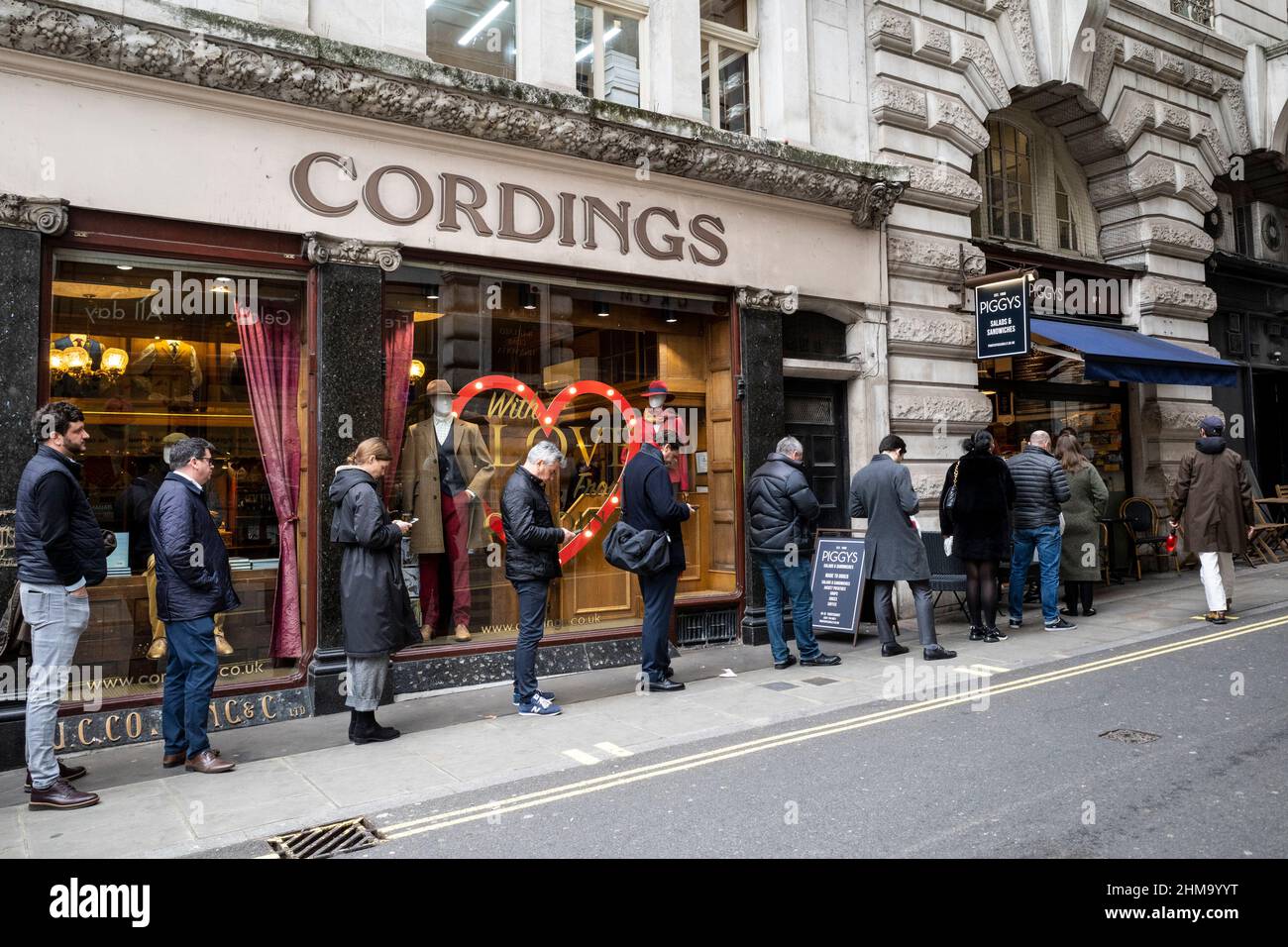 London, UK. 8 February 2022. Office workers form a long queue outside ...