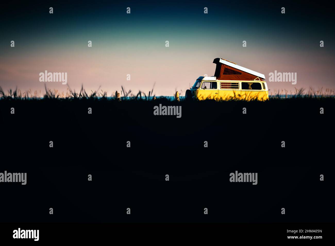 Campervan during sunset at the beach Stock Photo - Alamy