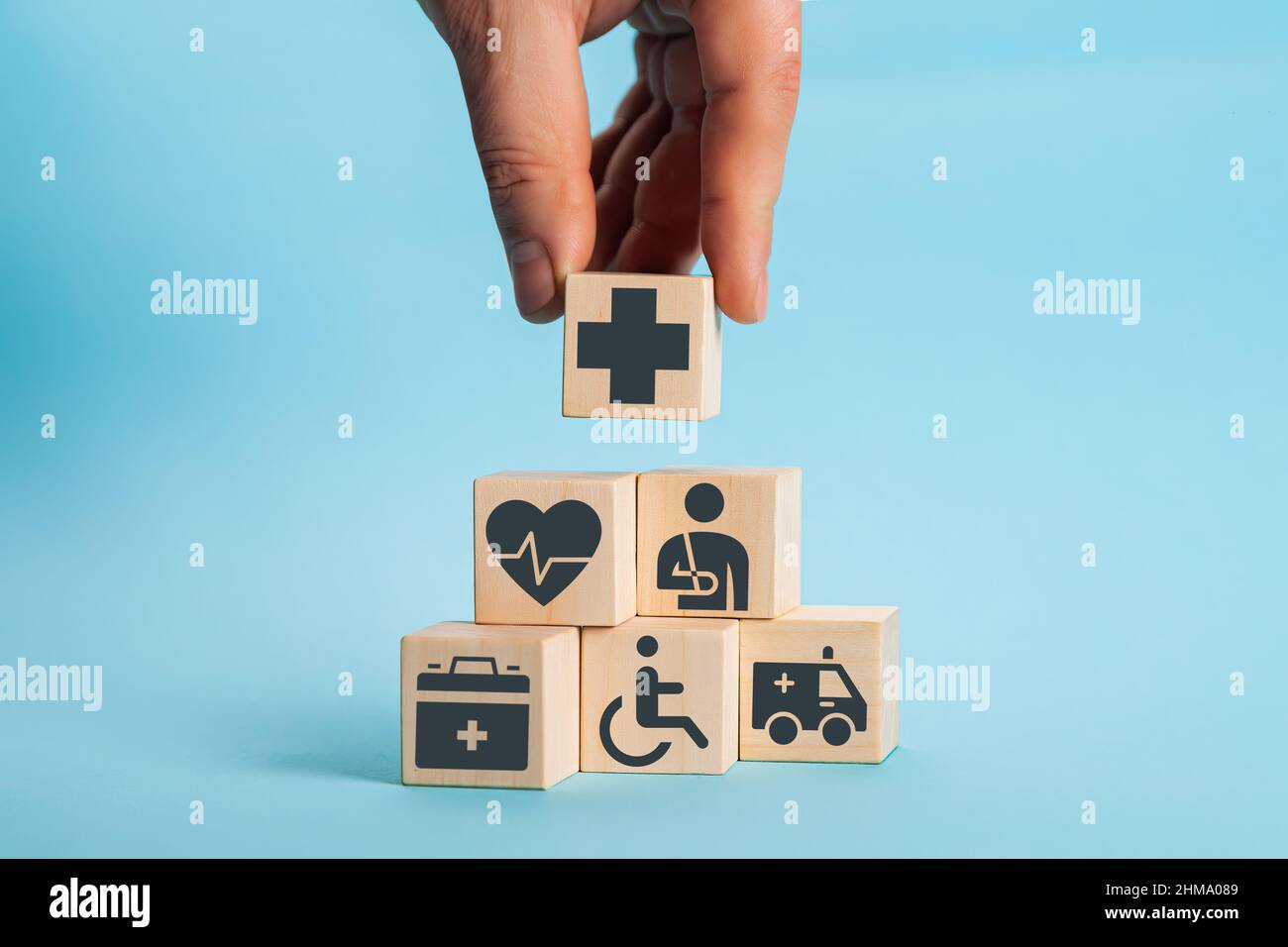 Hand arranging wood block stacking with the healthcare medical icon ...