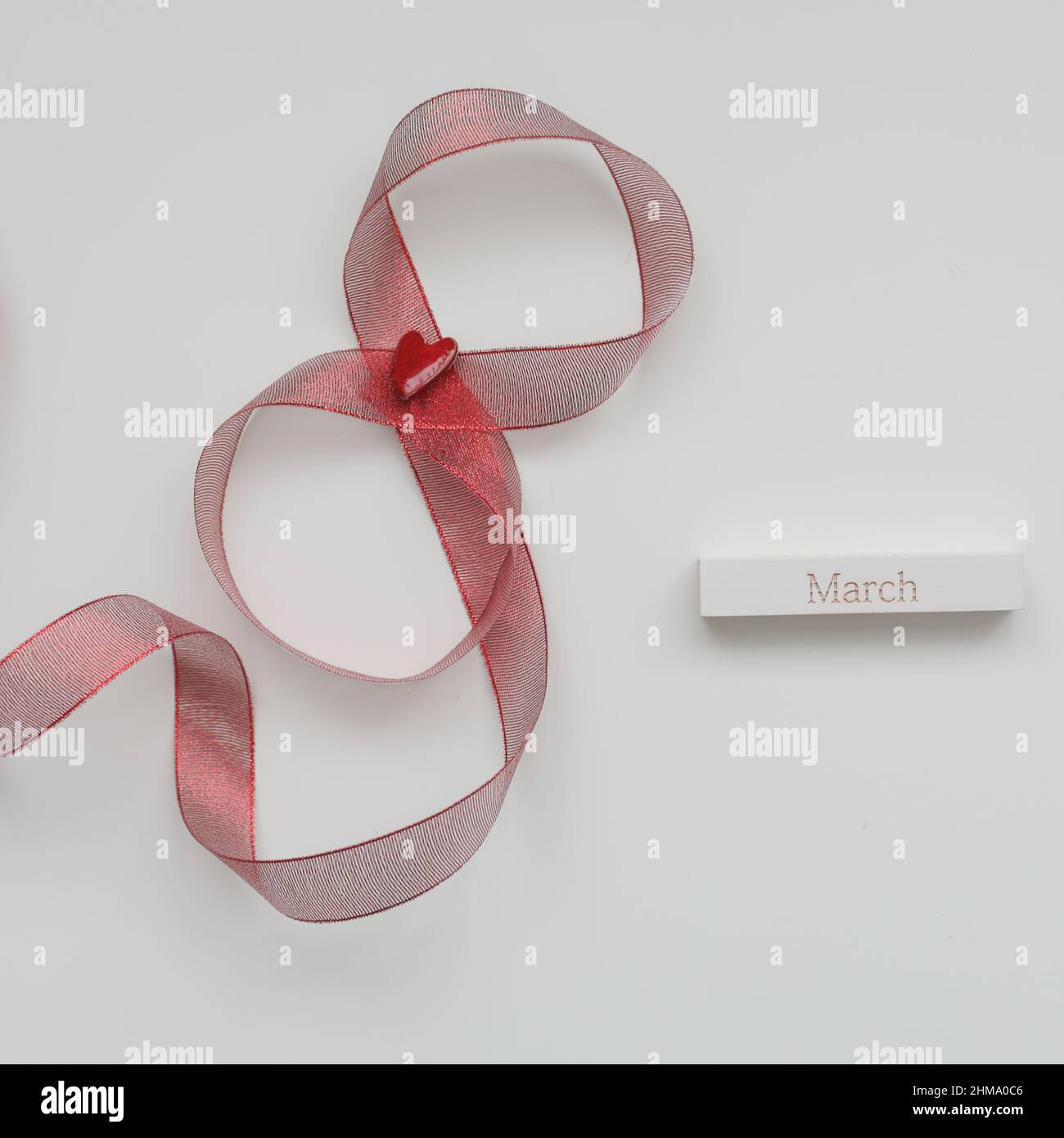 8 March, International Women's Day concept. Figure eight of red ribbon ...