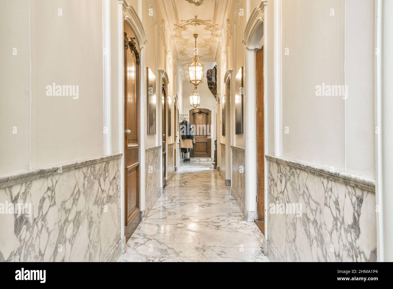 Corridor with wooden doors and marble floor with glowing classic ...