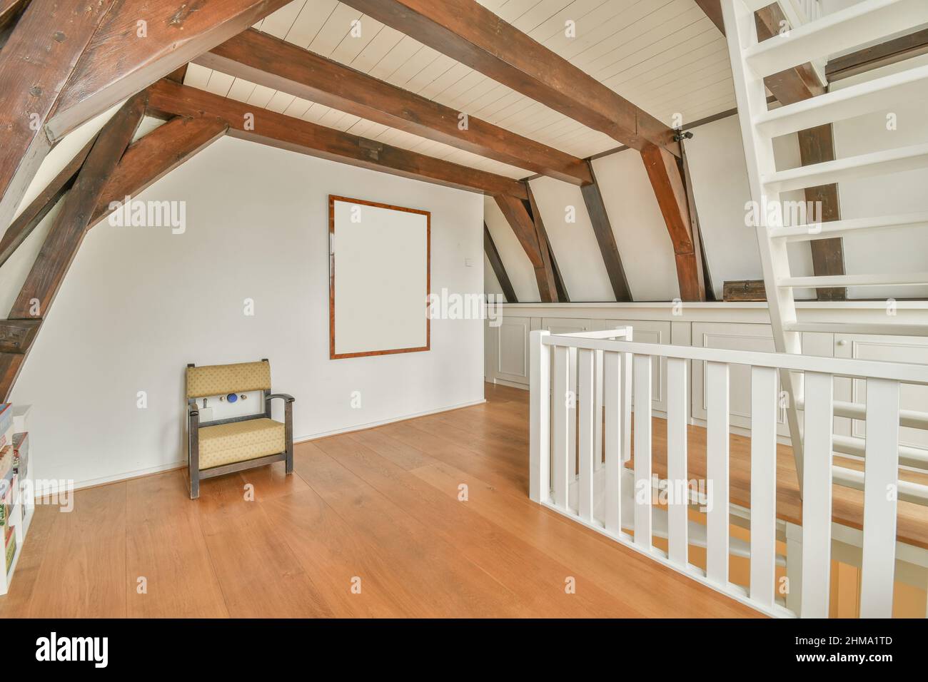 Comfortable chair placed at wall with decorative frame in hallway with ...