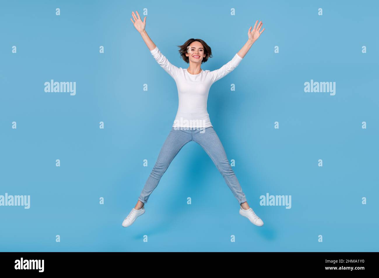 Full size photo of excited crazy cheerful girl jumping in star pose ...