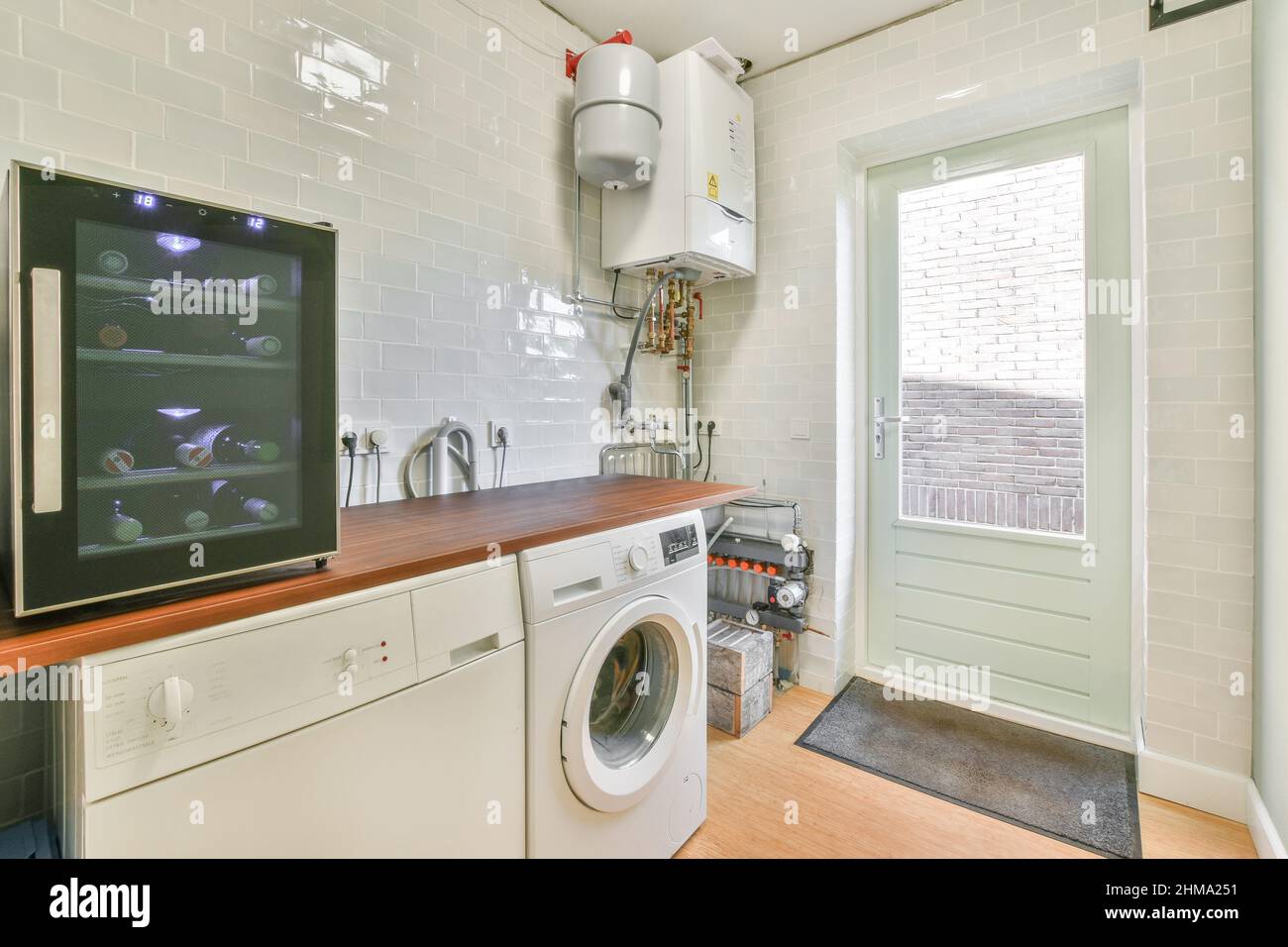 Wine fridge with collection of alcoholic drinks placed near modern ...