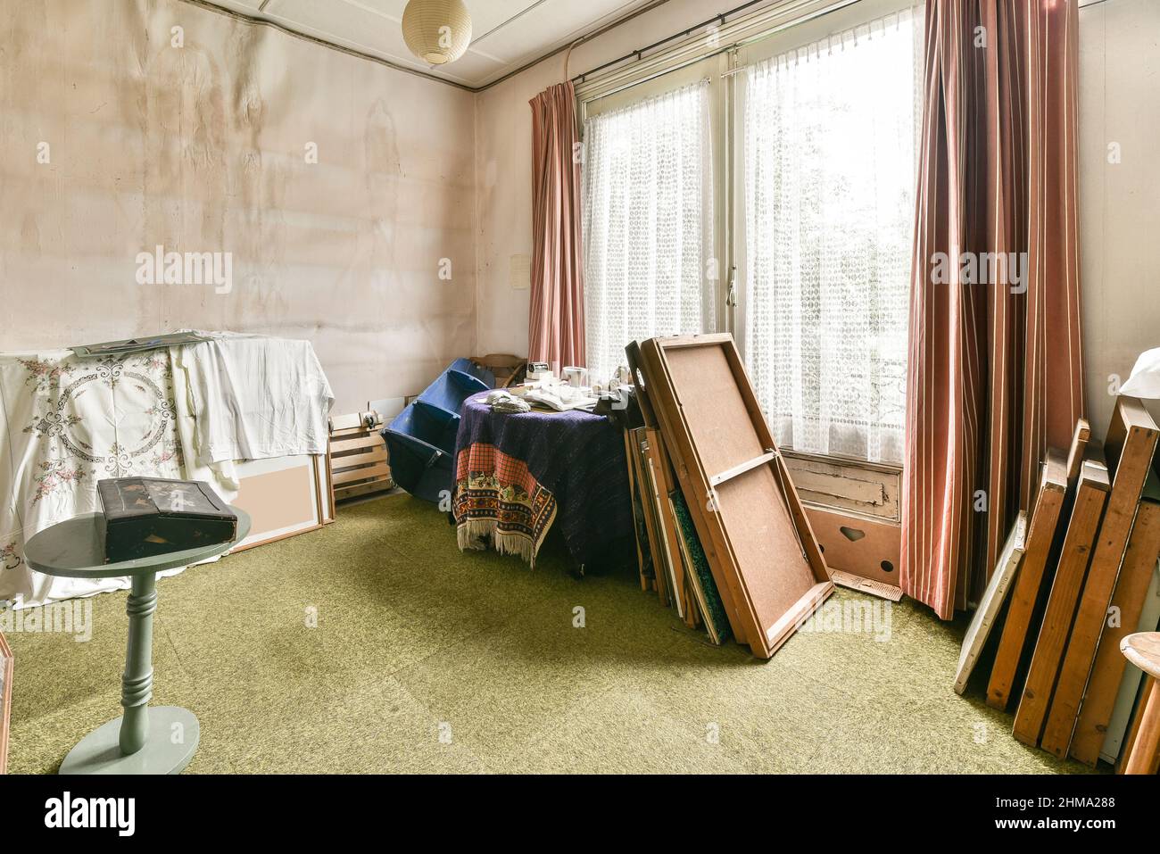 Interior of room with various old stuff like paintings and furniture ...