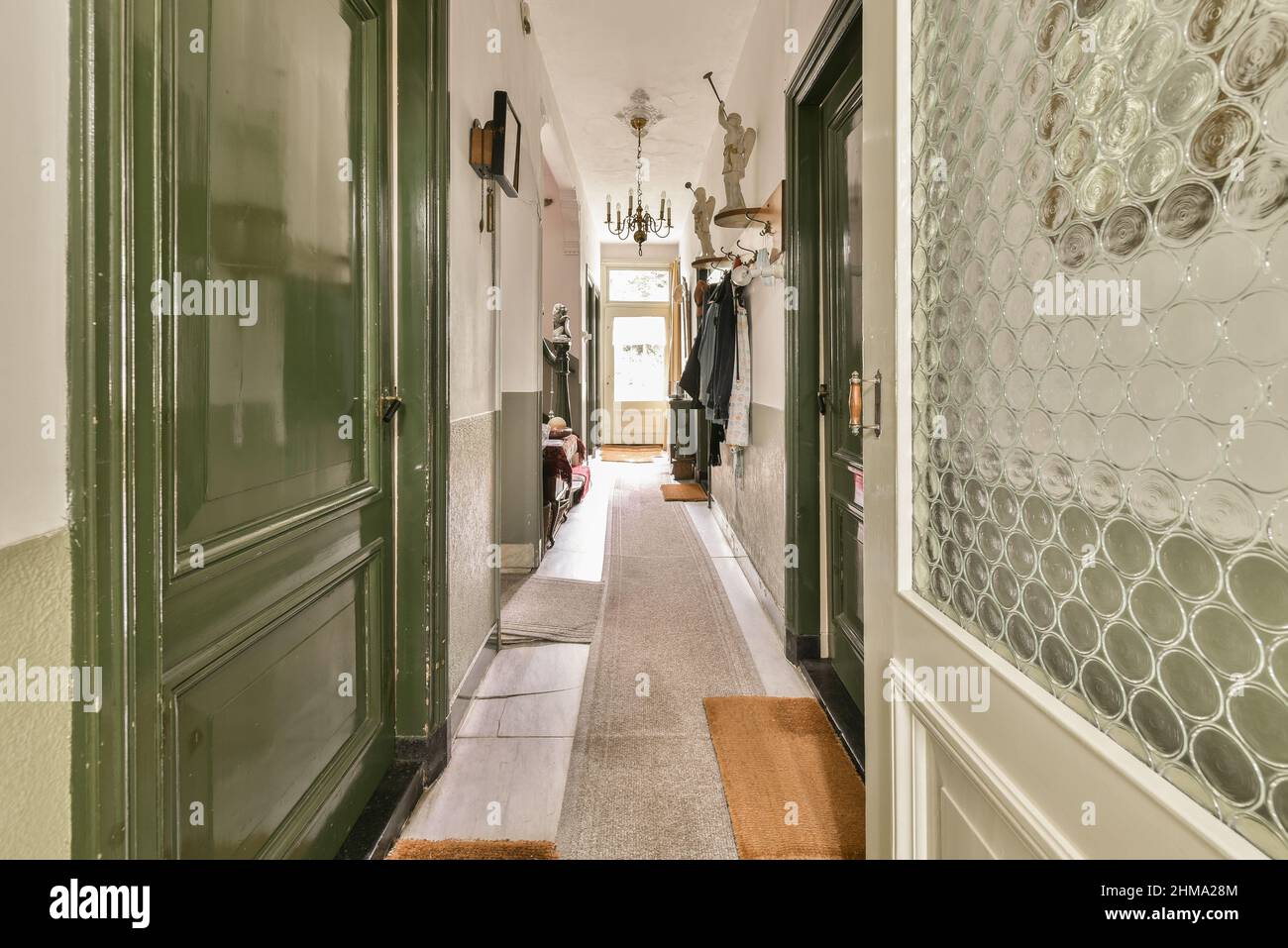 Interior of long hallway with doors leading to flats in old fashioned ...