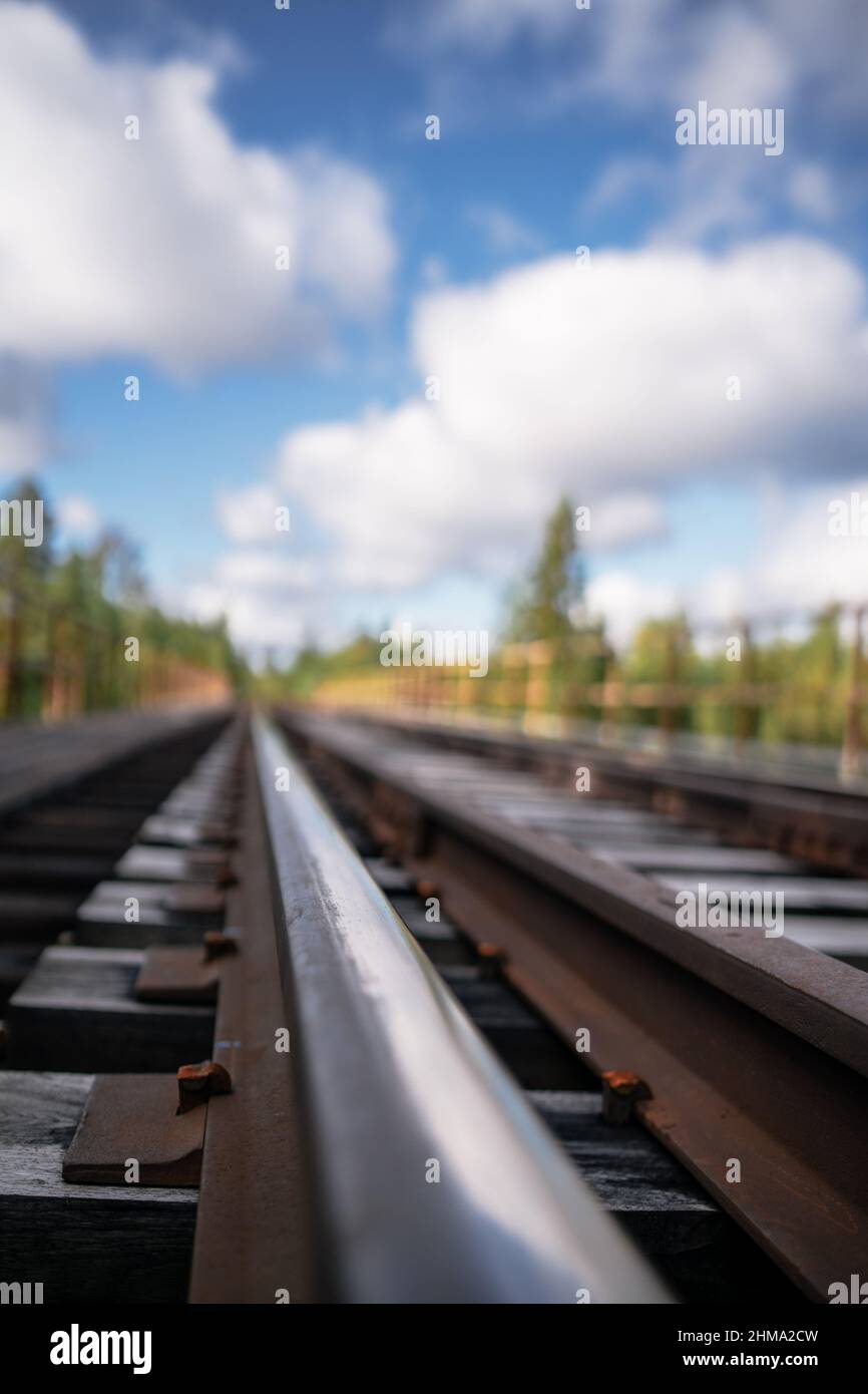 Vertical shot of a railroad on the blurry background Stock Photo - Alamy
