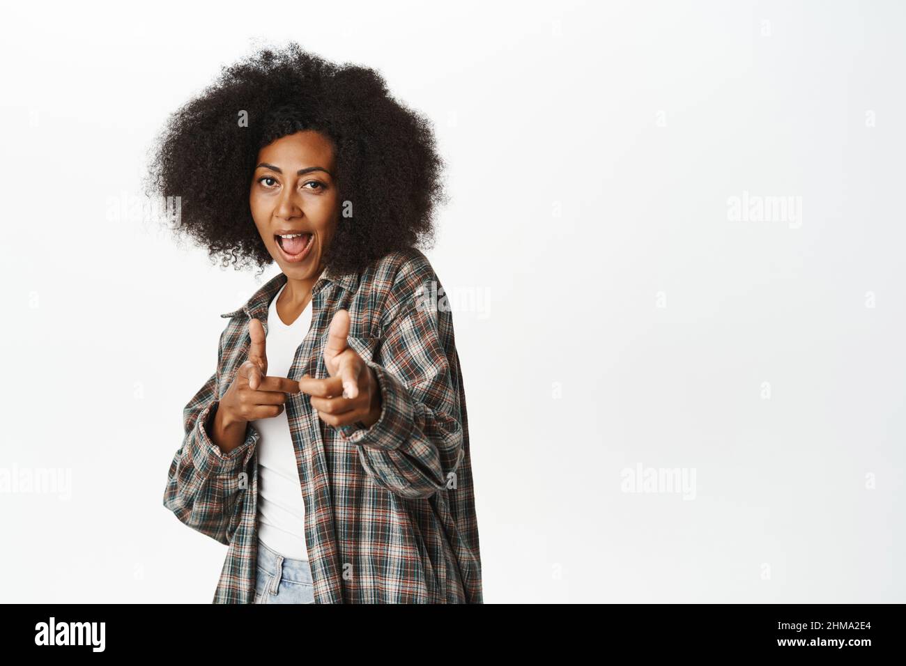 Bang. Happy african american woman pointing fingers at camera, choosing ...