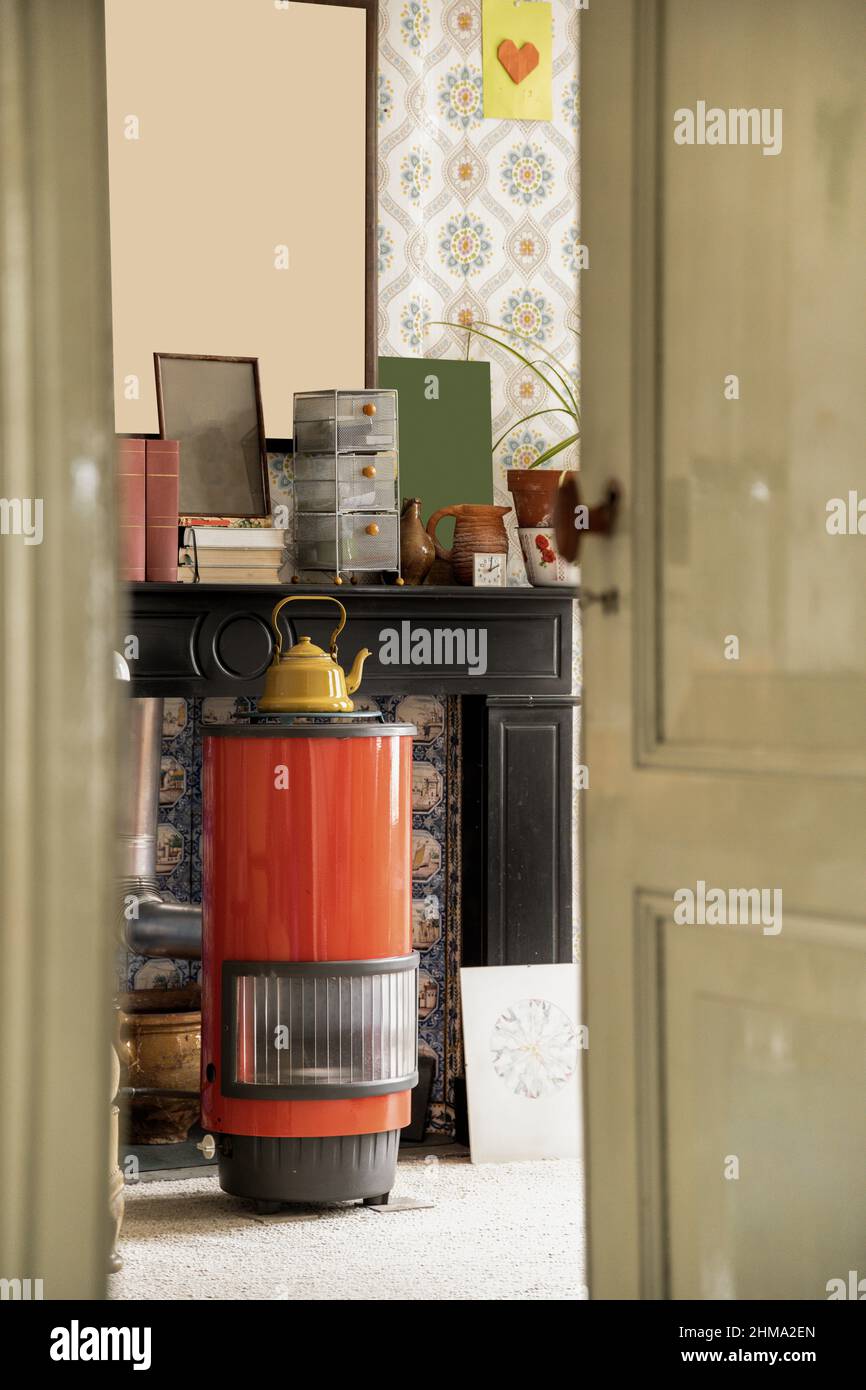 Interior of room with old fashioned potbelly stove with kettle placed ...