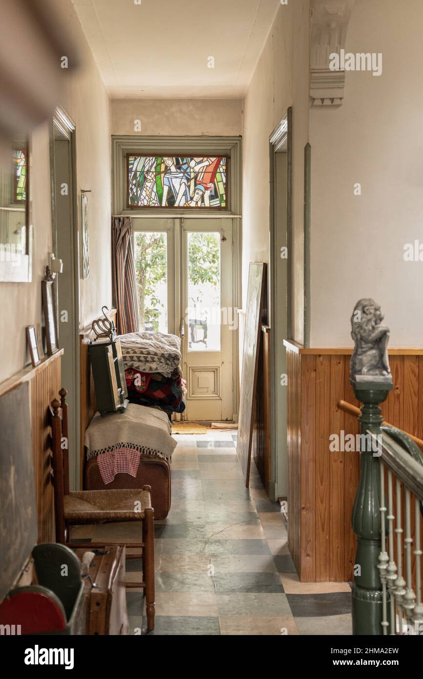 Narrow corridor in shabby country house with old fashioned wooden ...