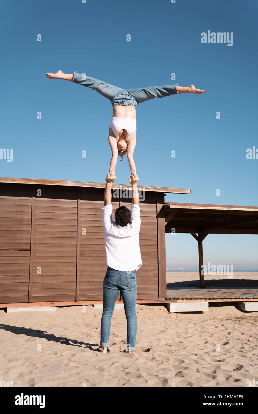 Full body of unrecognizable sportive couple performing hand to hand ...