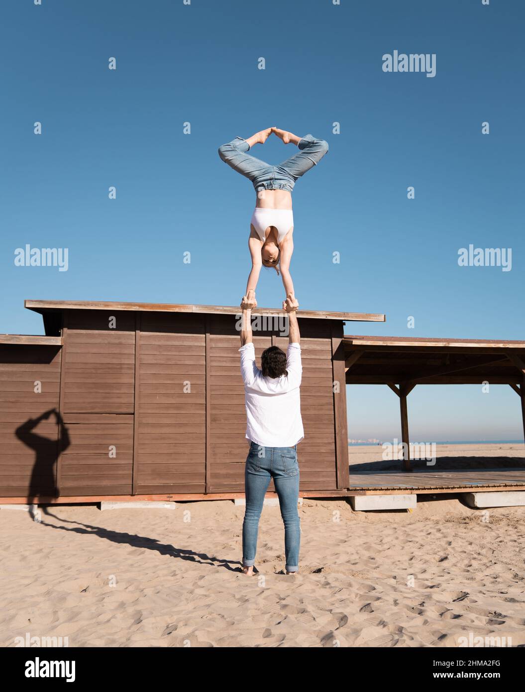 Full body of unrecognizable sportive couple performing hand to hand ...