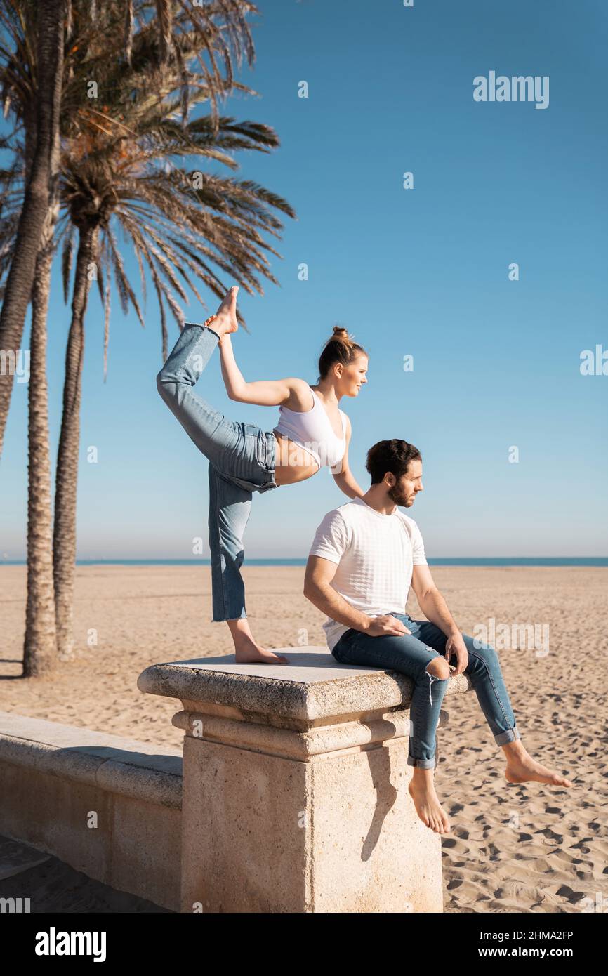 Full body side view of active female performing Lord of the dance asana ...