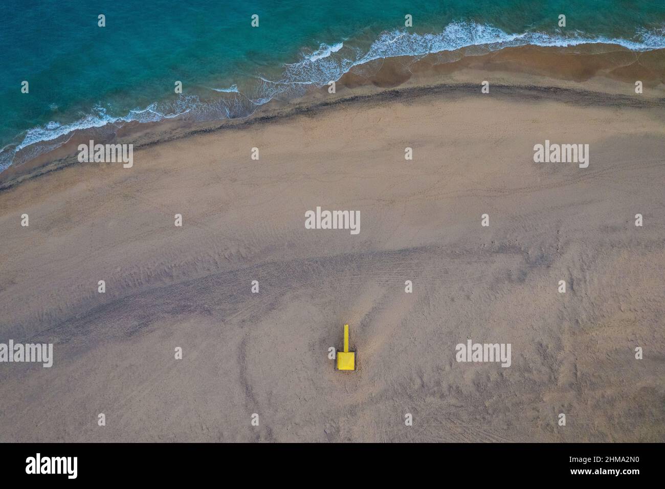 Spectacular aerial top view of bright yellow lifeguard tower located on ...