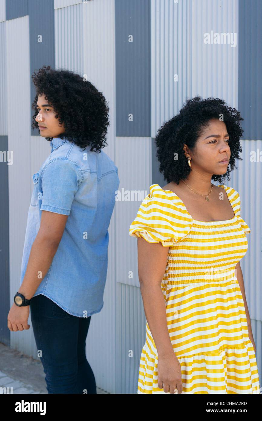 Side view disconnected ethnic couple having conflict and ...
