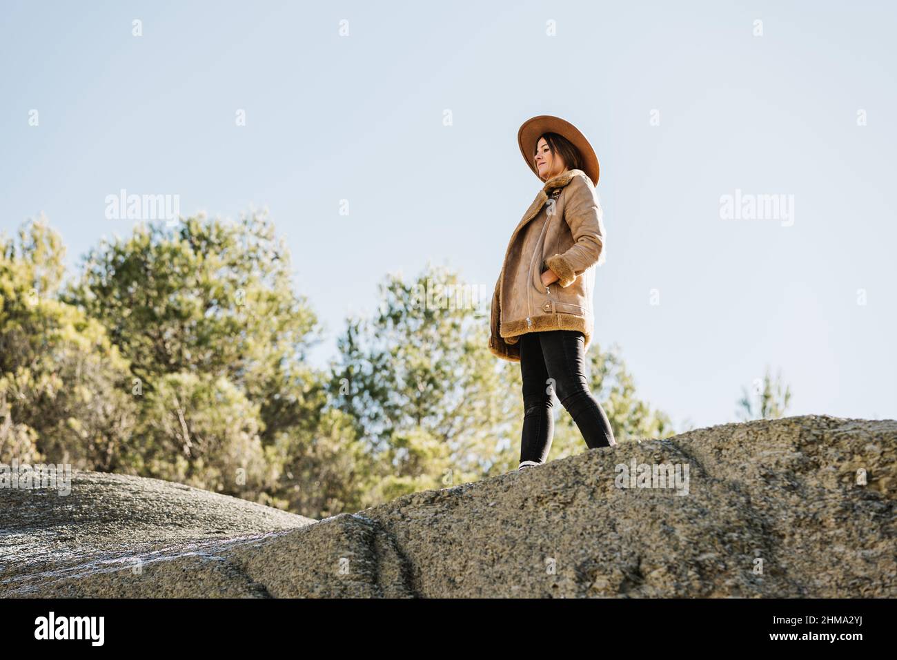 From above unrecognizable person foot standing on rock surface near ...