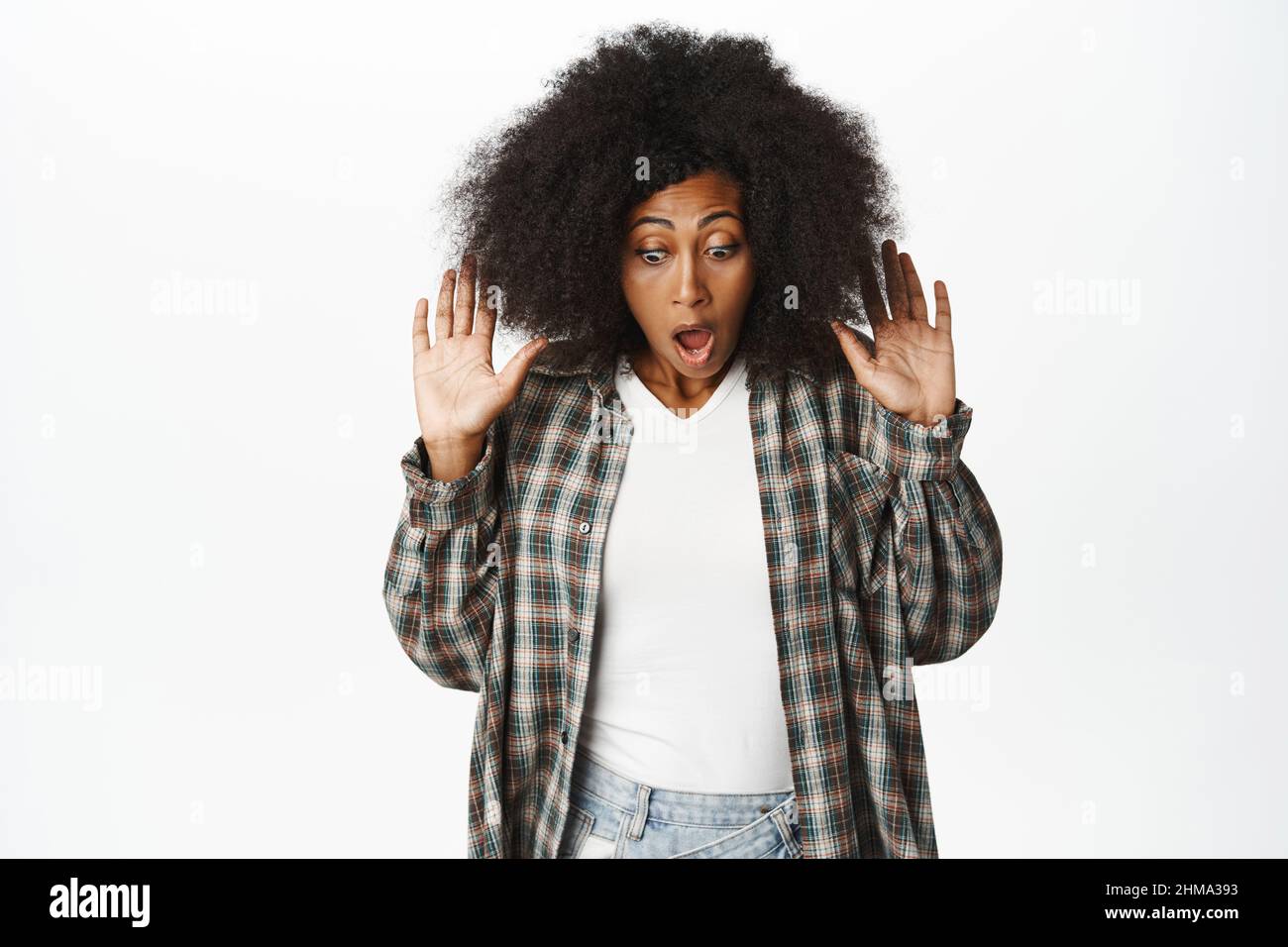 Portrait of shocked african woman drop smth down, raising hands up and ...