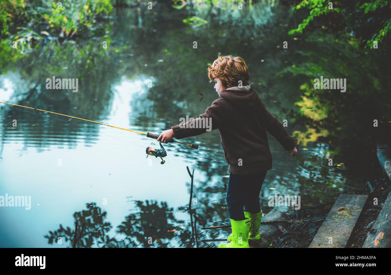 Cute child little boy pulling rod while fishing on lake Stock Photo - Alamy