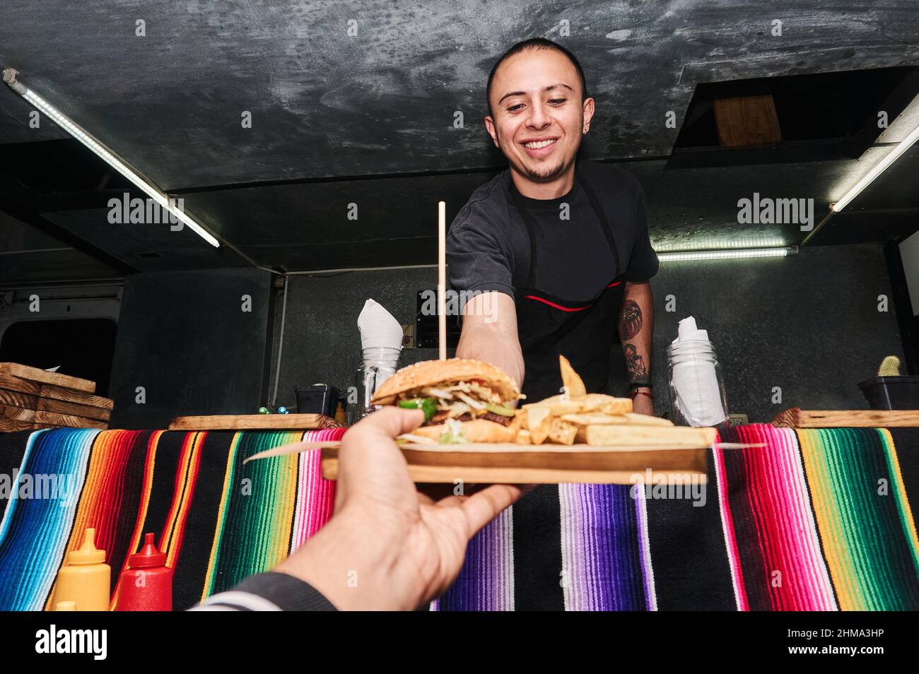 Hand of faceless unrecognizable buyer getting order with fast food from ...