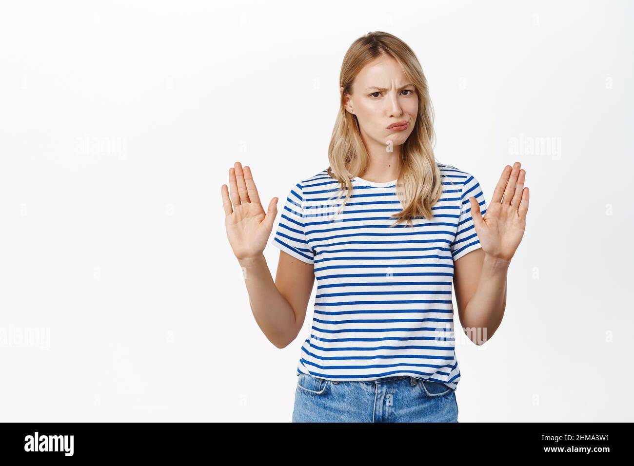 Portrait of woman showing stop sign, raising hands up, prohibit action ...