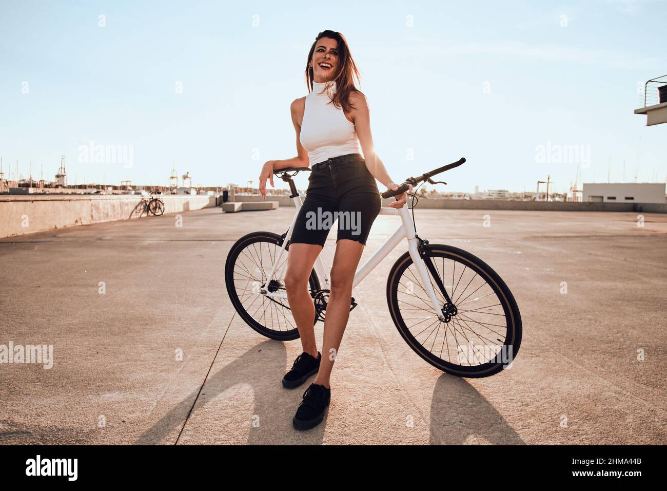 Full body of cheerful young female with long hair in casual clothes ...