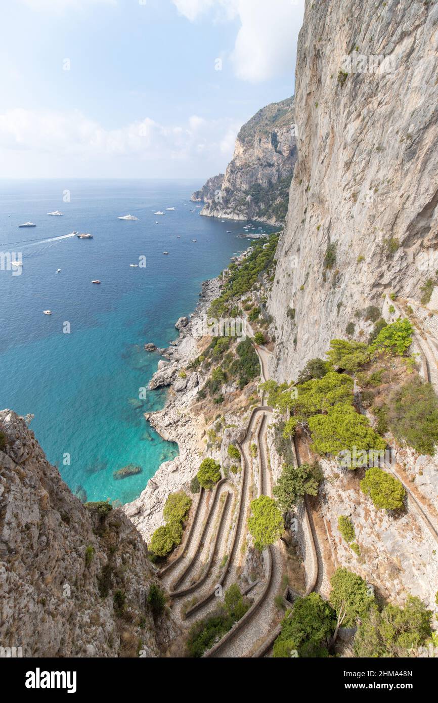 Top view of narrow winding roadway on coast with rocky cliff and ...