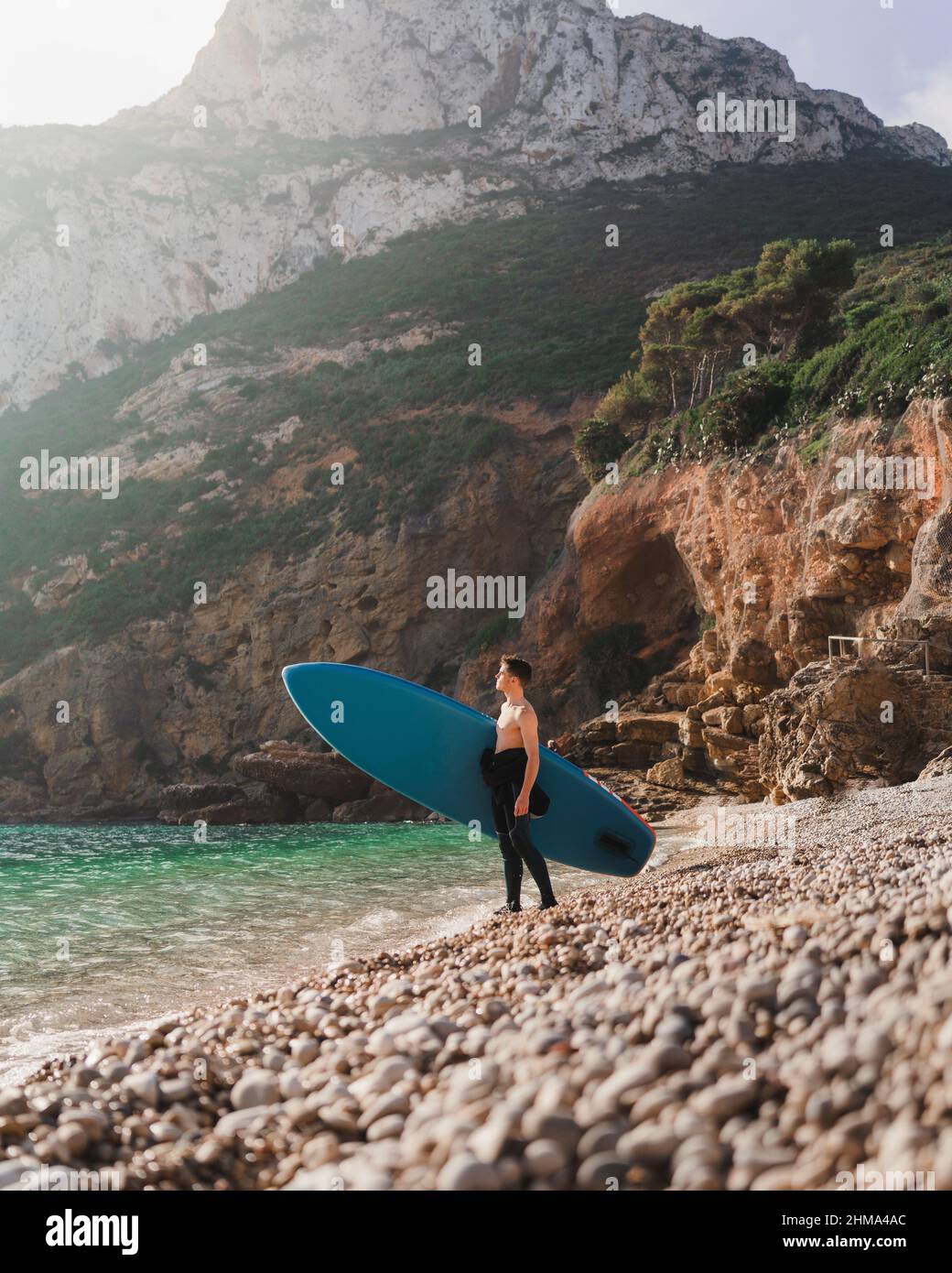 Side view of full body male surfer with SUP board for paddle surfing ...